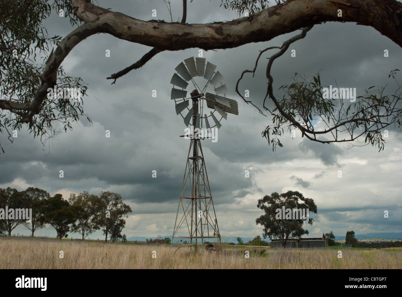Farm Windmill and rain clouds Stock Photo - Alamy