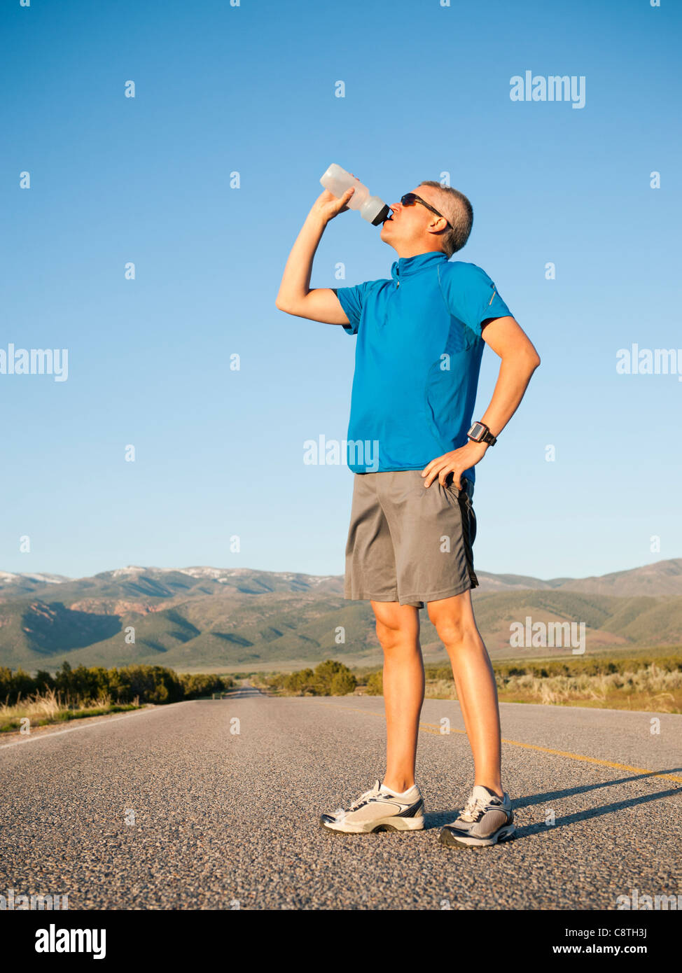 USA, Utah, Kanosh, Mid adult an drinking water while taking break from ...