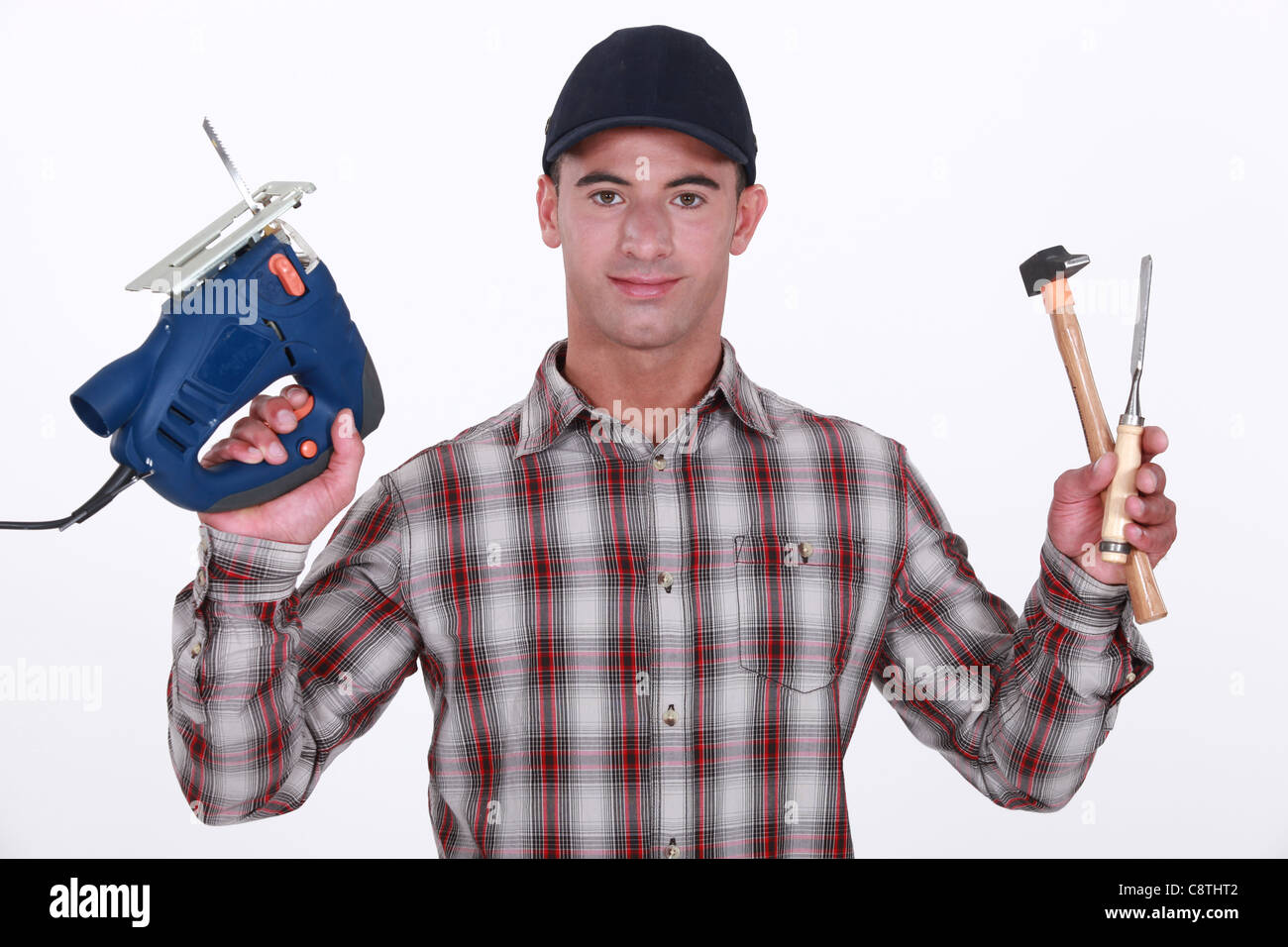 Man holding band-saw, hammer and chisel Stock Photo - Alamy