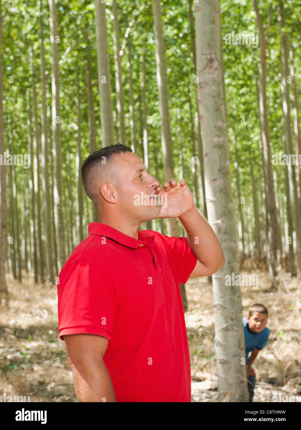Child hiding between trees hi-res stock photography and images - Alamy