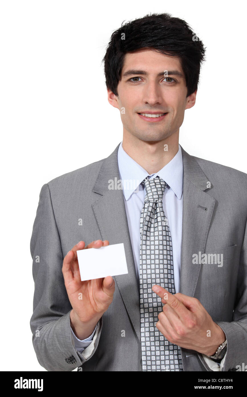 Businessman pointing at blank card Stock Photo - Alamy