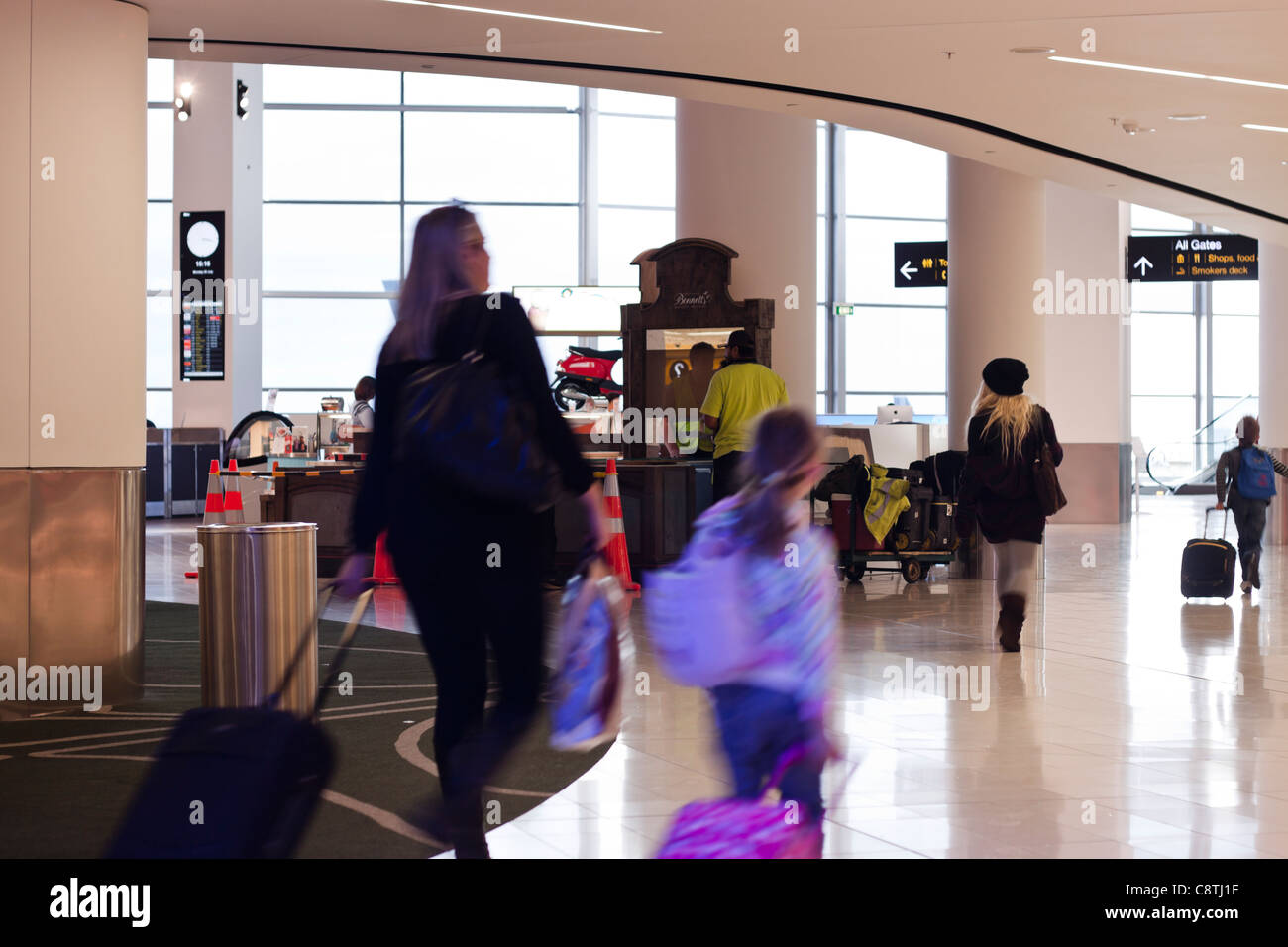 Airport rush, motion blurred, people running through airport hall ...