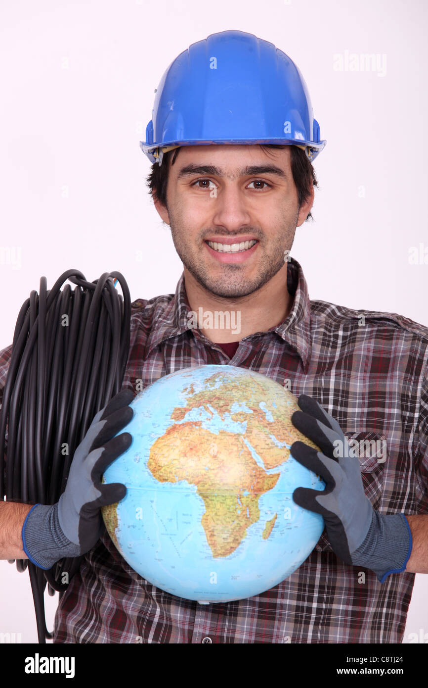 Electrician with a globe in his hands Stock Photo - Alamy