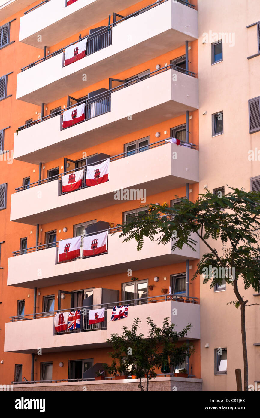 Block of flats with flags on the balcony. Detail of block in Gibraltar ...
