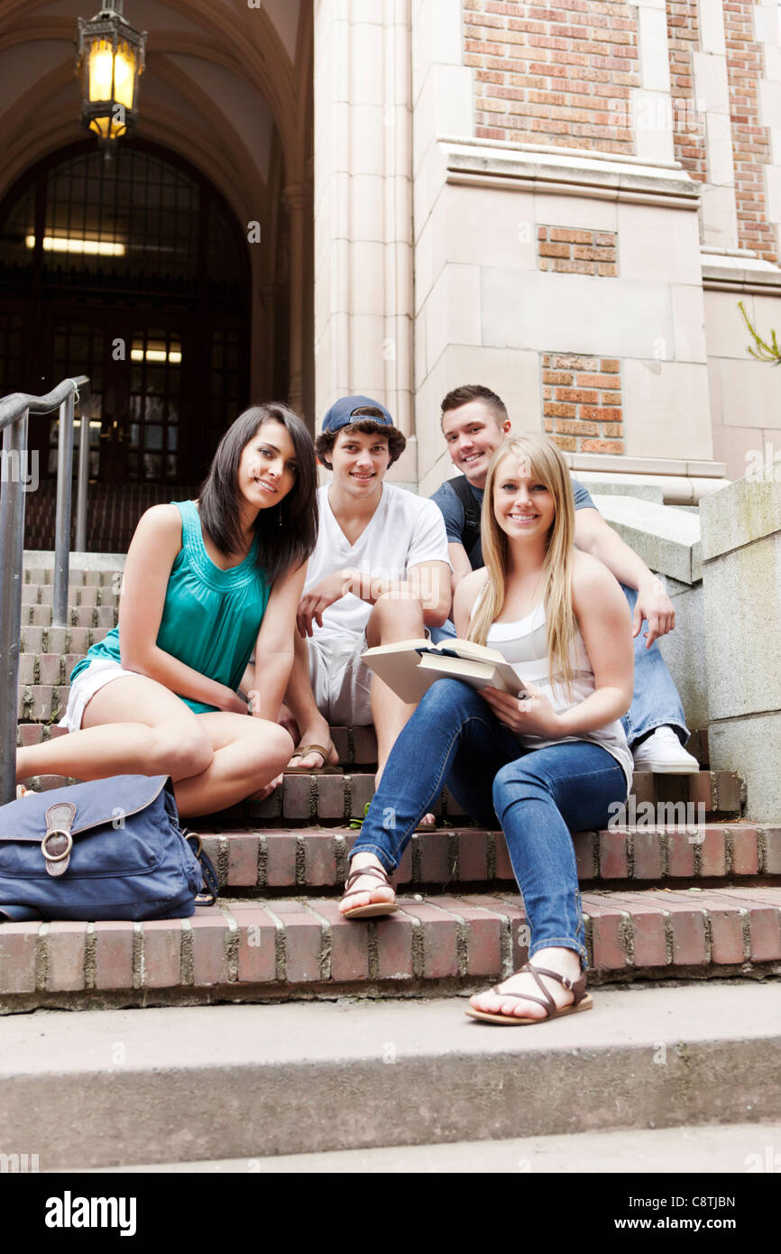 USA, Washington, Seattle, Portrait of four college students sitting on ...