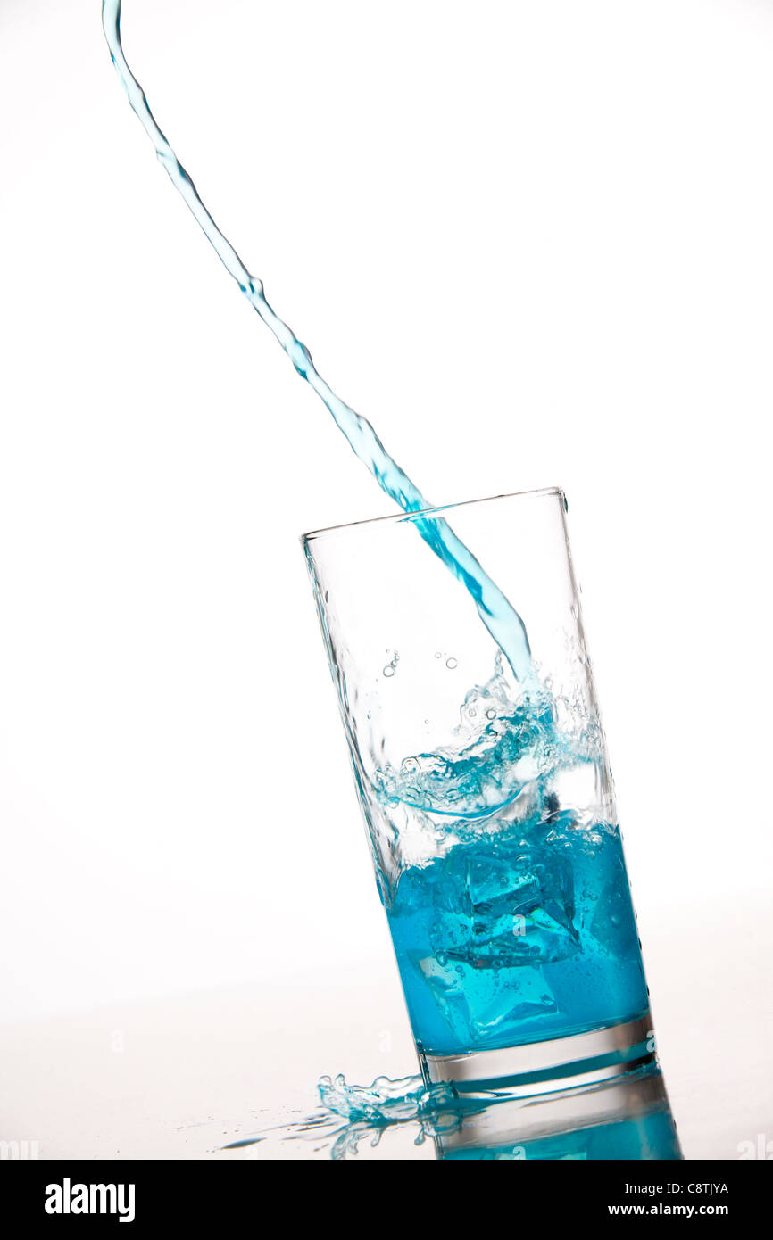 Blue Drink Pouring In A Glass Stock Photo - Alamy