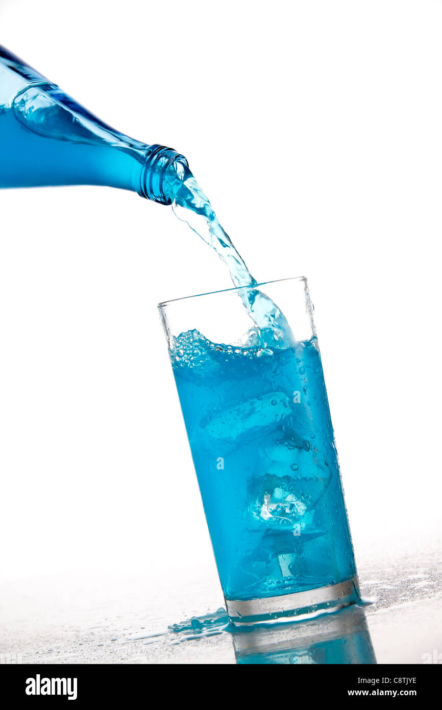Blue Drink Pouring In A Glass Stock Photo - Alamy