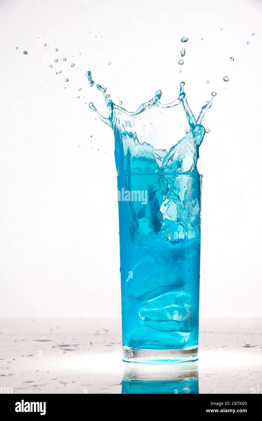 Blue Drink Splashing In A Glass Stock Photo - Alamy