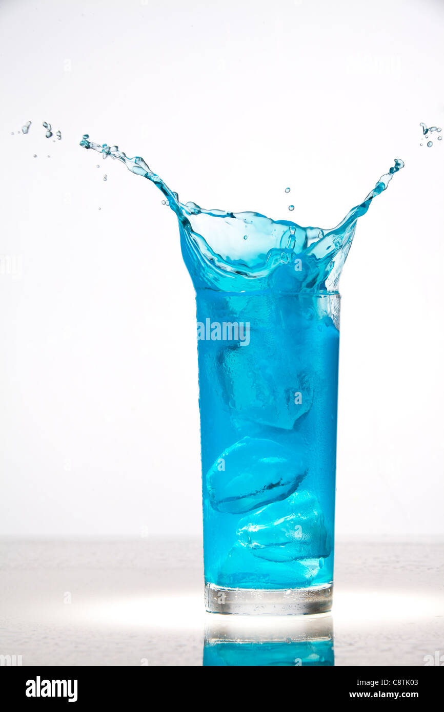 Blue Drink Splashing In A Glass Stock Photo - Alamy