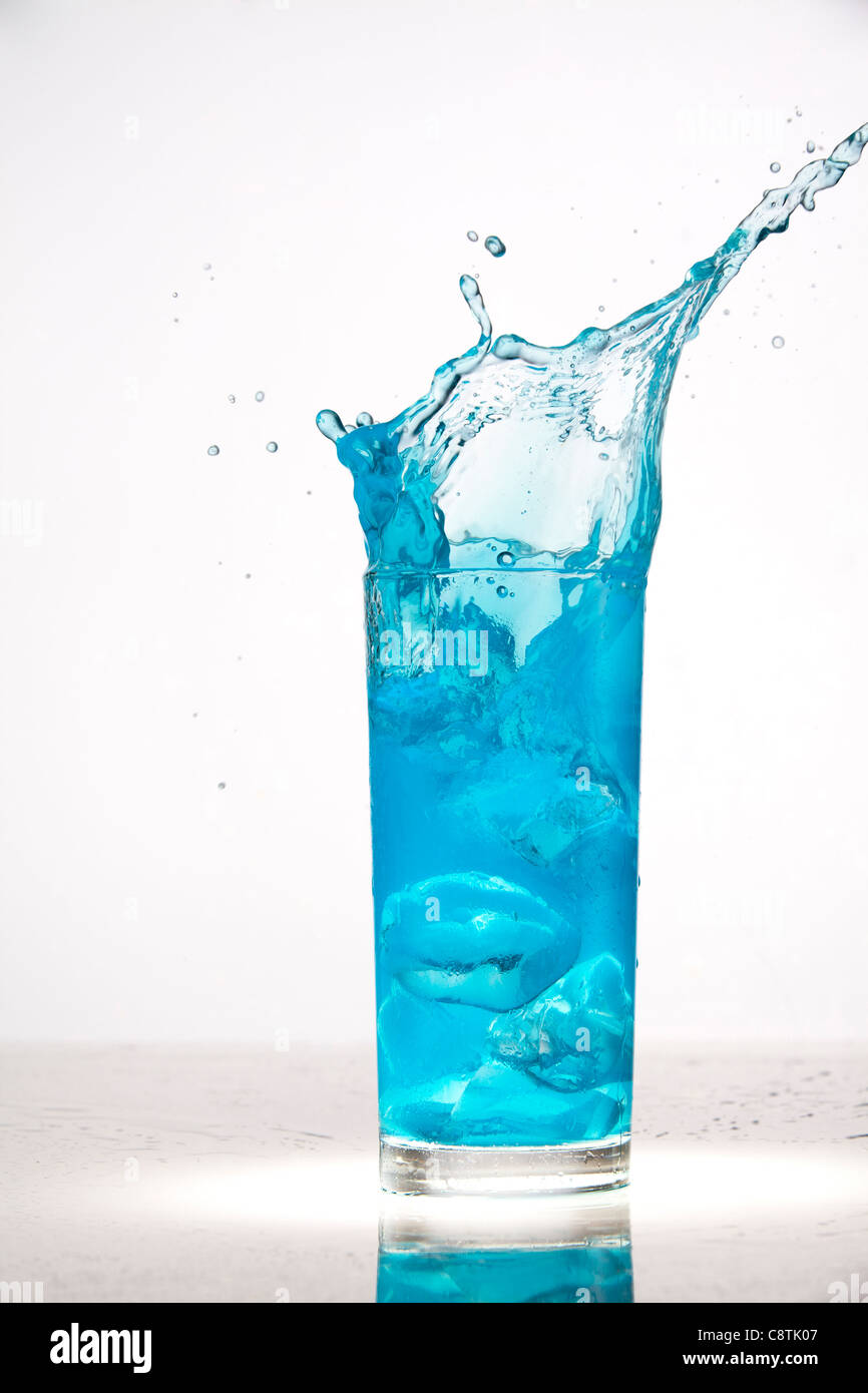 Blue Drink Splashing In A Glass Stock Photo - Alamy
