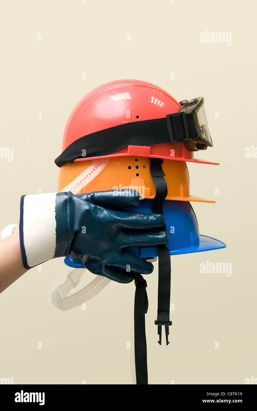 Hand hold three colored helmets Stock Photo - Alamy