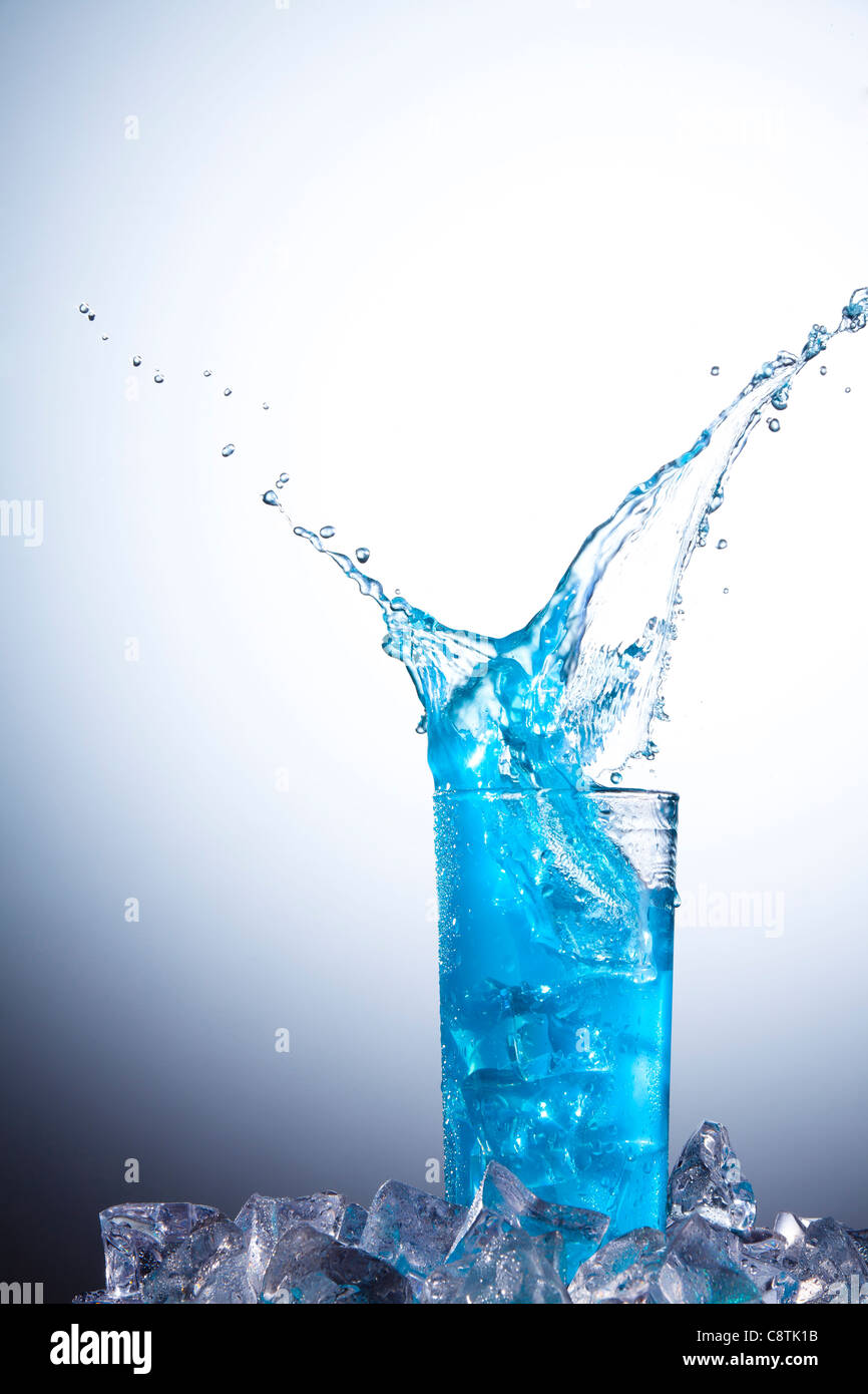 Blue Drink Splashing In A Glass Stock Photo - Alamy