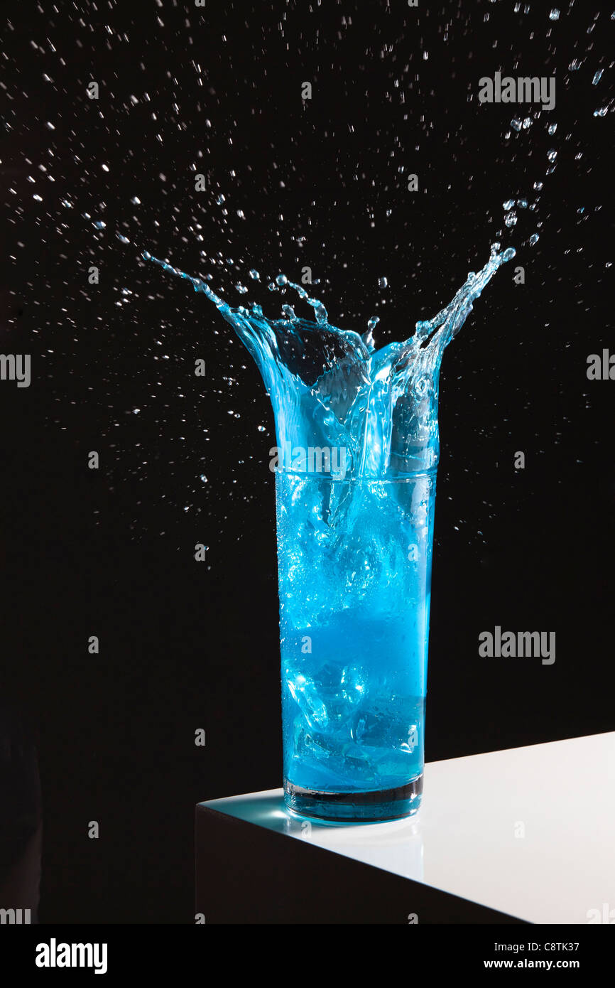 Blue Drink Splashing In A Glass Stock Photo - Alamy