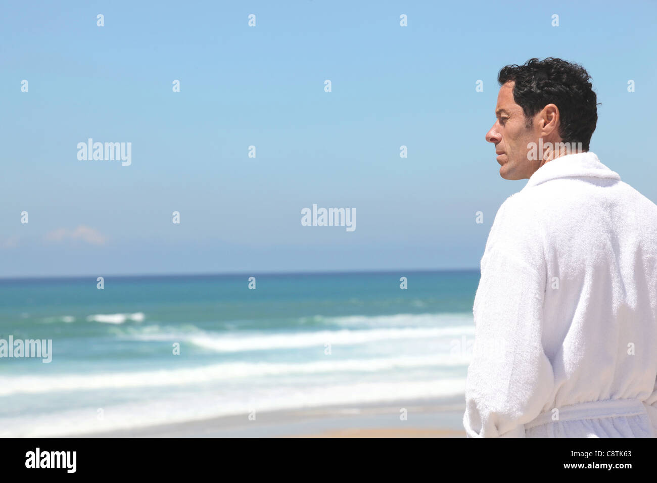 Man at the beach thinking Stock Photo - Alamy