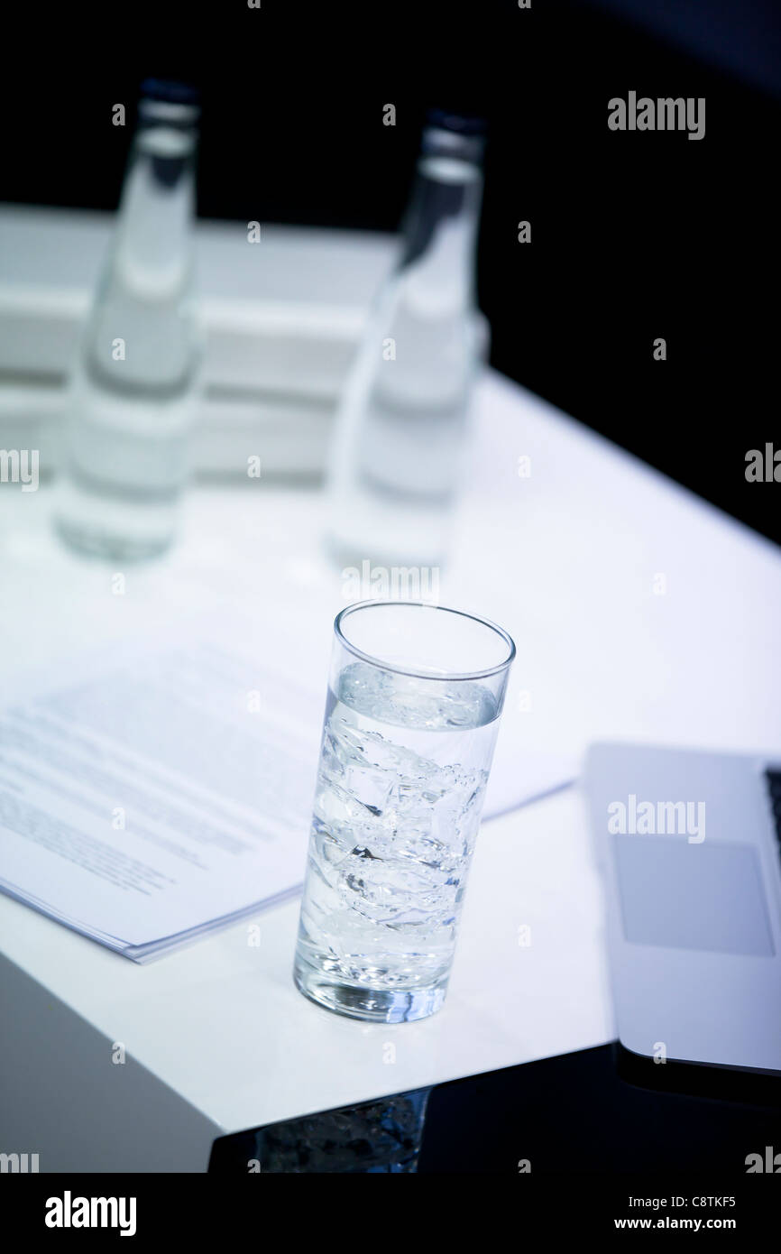 Water In A Glass With Laptop And Paper Stock Photo - Alamy