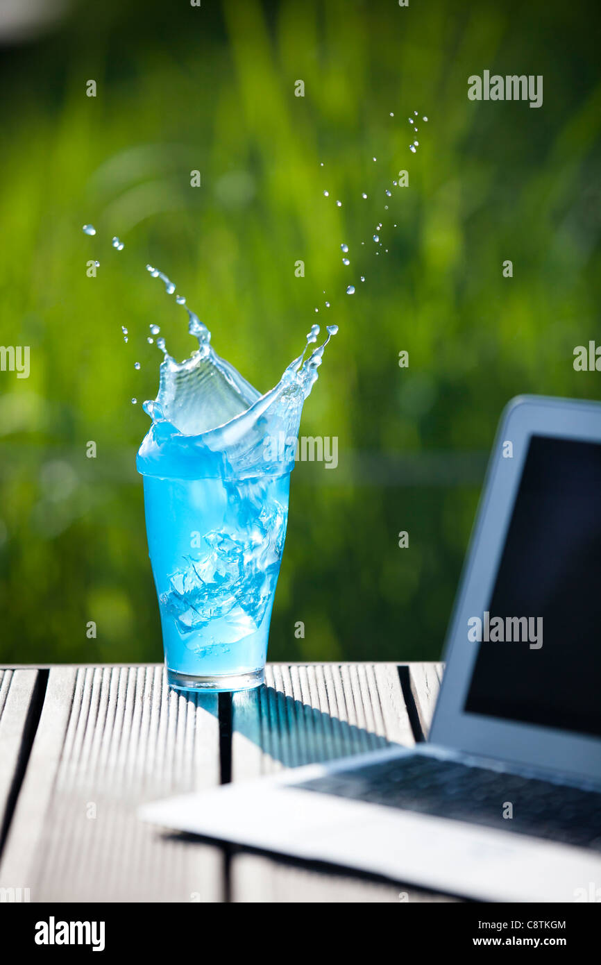 Blue Drink Splashing In A Glass Stock Photo - Alamy