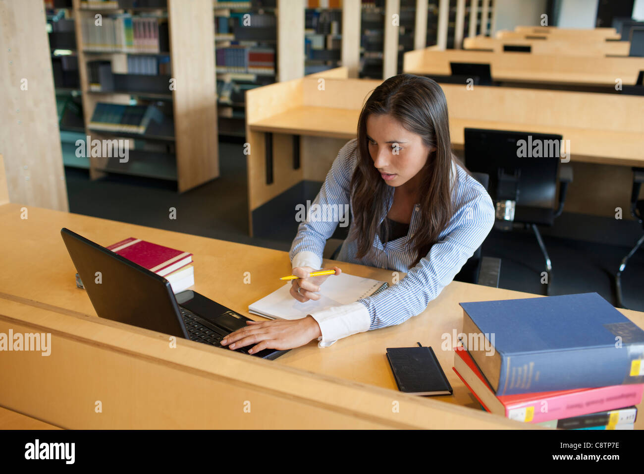 Netherlands, Maastricht, Female student studying in library Stock Photo ...