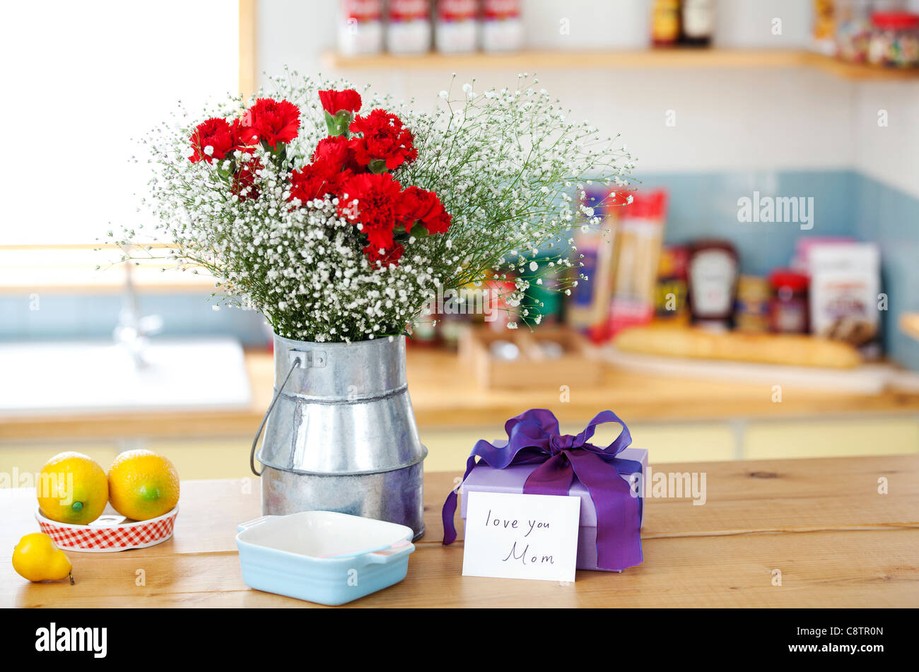 Wrapped Gift Box And Bunch Of Flower On The Kitchen Counter Stock Photo ...