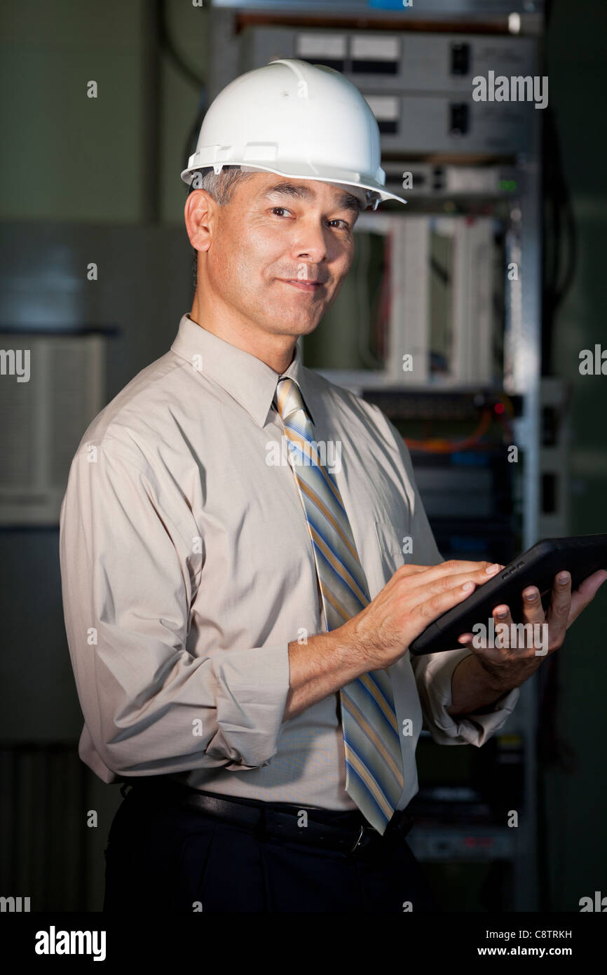 USA, New Mexico, Santa Fe, Portrait of male technician wearing hardhat ...
