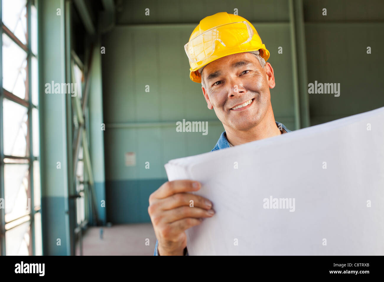 USA, New Mexico, Santa Fe, Portrait of architect holding blueprint ...