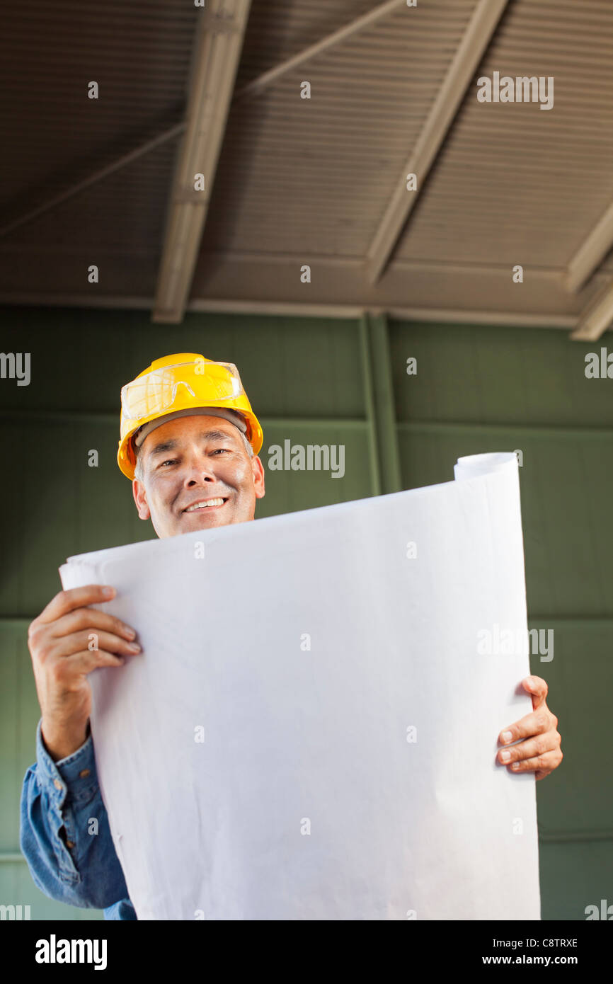 USA, New Mexico, Santa Fe, Portrait of architect holding blueprint ...