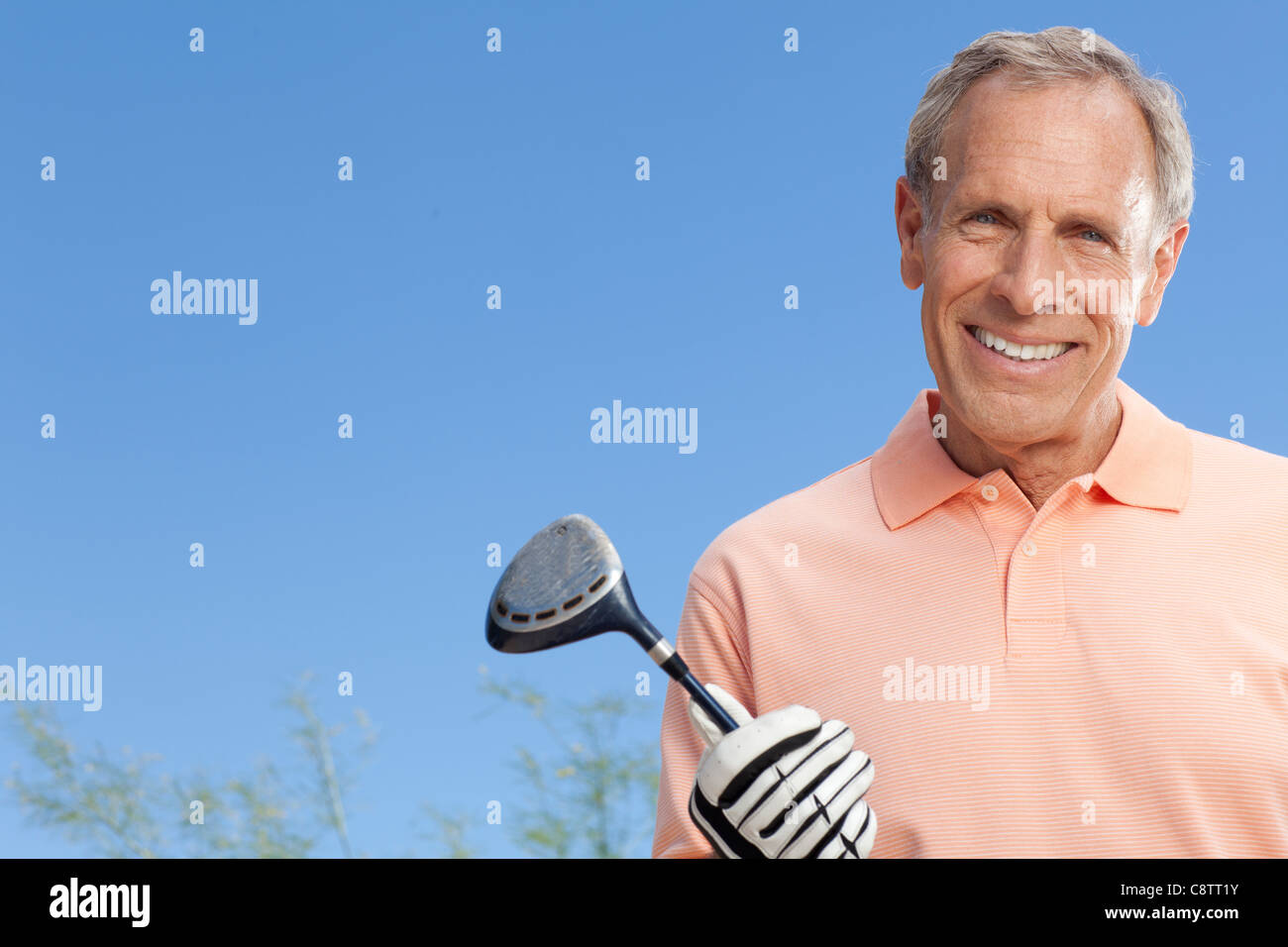 USA, Arizona, Scottsdale, Portrait of senior man holding golf club ...