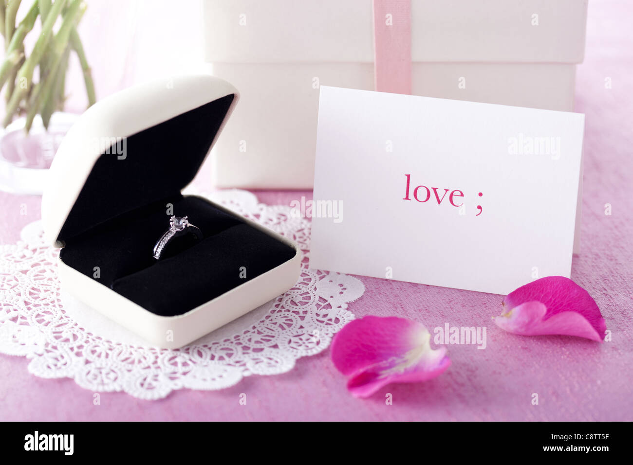 Engagement Ring Box With Gift Box And Rose Petals Stock Photo - Alamy