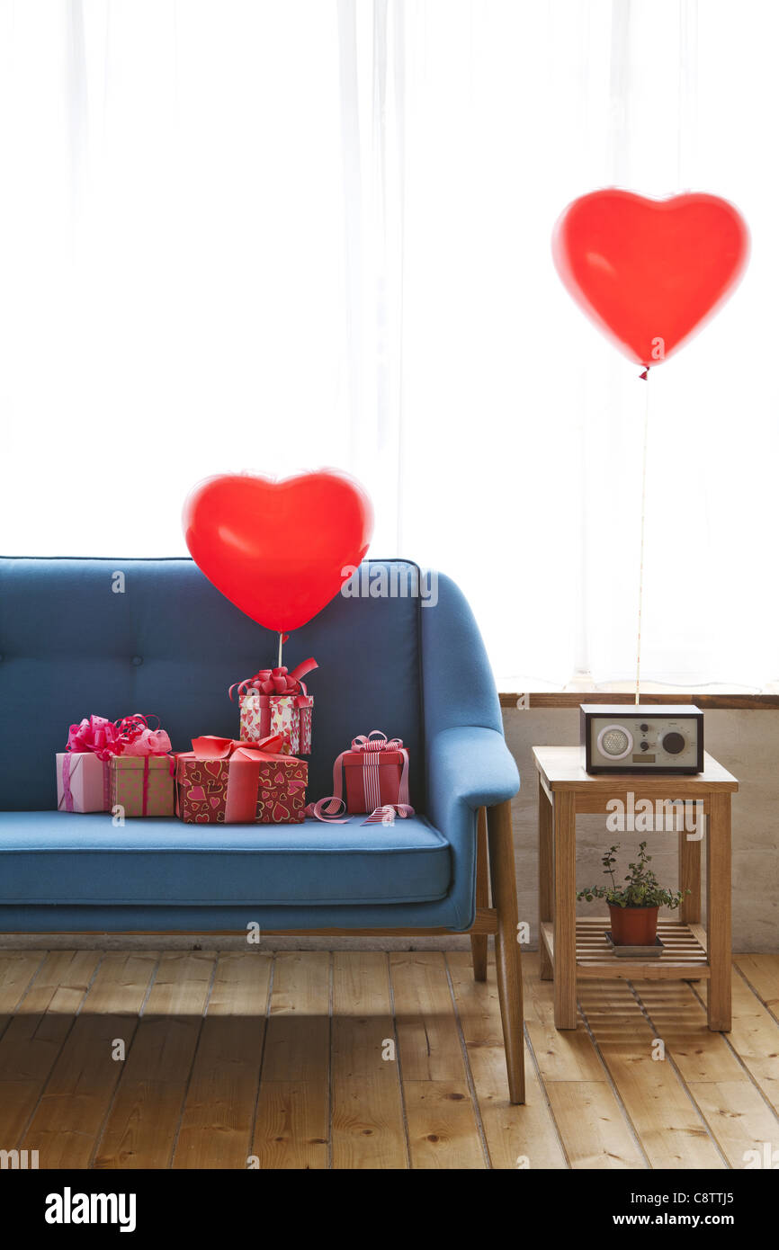 Gifts And Red Balloon On Couch Stock Photo - Alamy