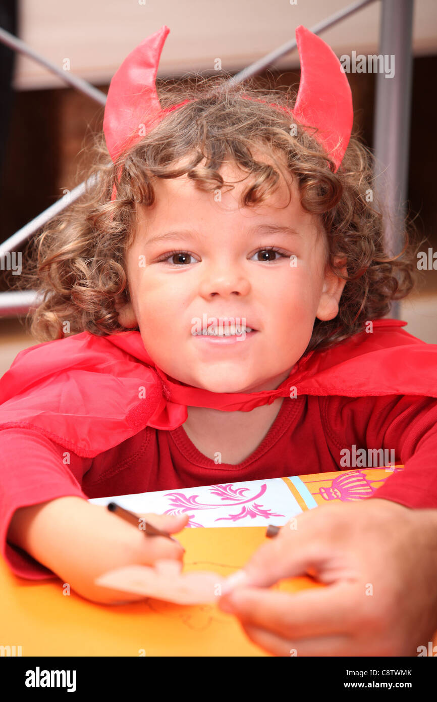 Portrait of child dressed up as devil Stock Photo - Alamy