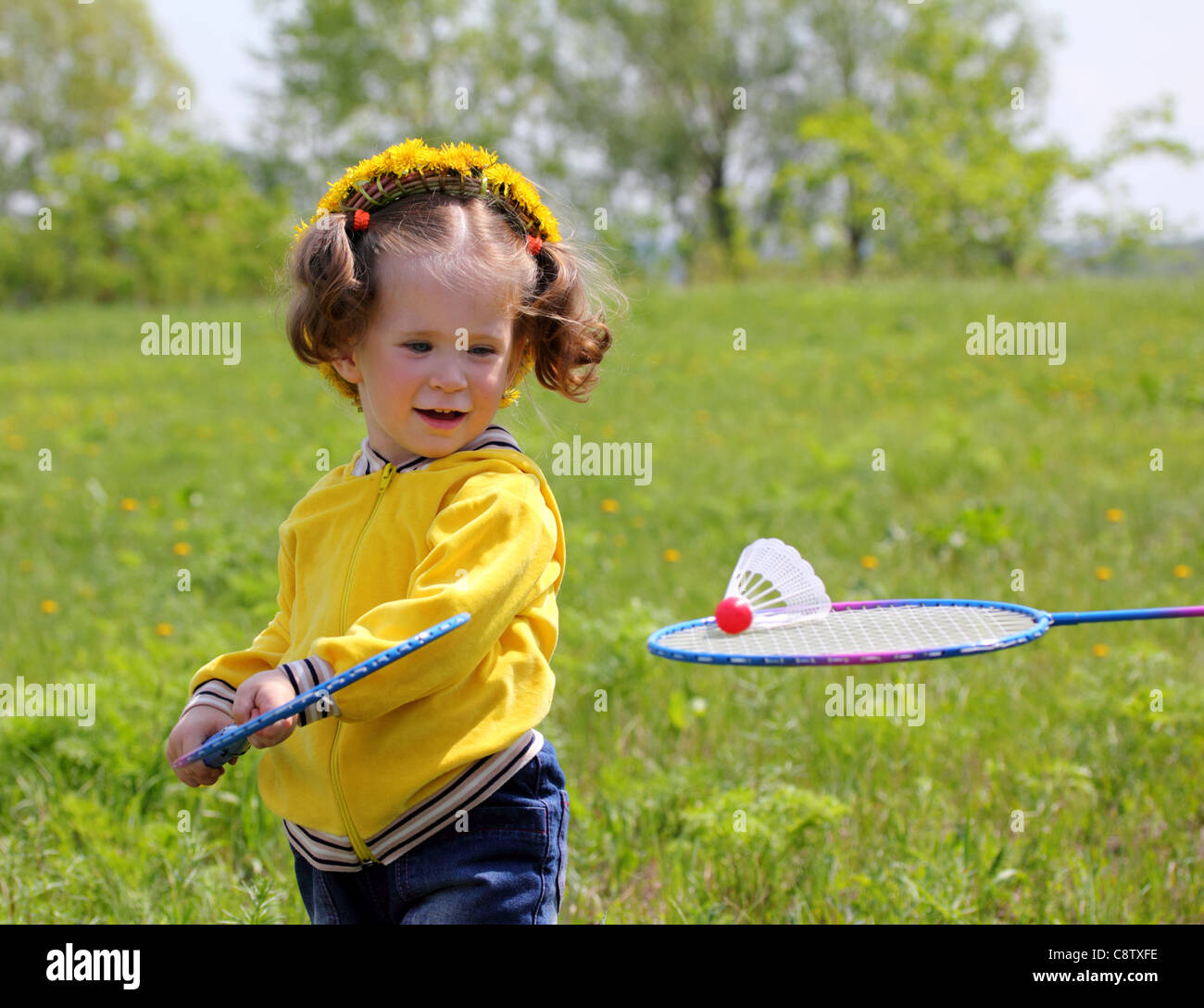little girl playing badminton on spring meadow Stock Photo - Alamy