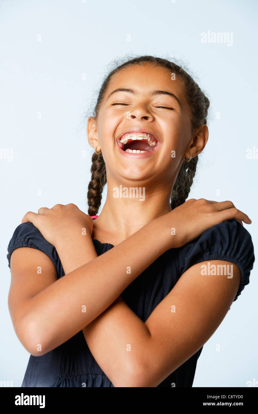 Studio portrait of girl laughing Stock Photo - Alamy