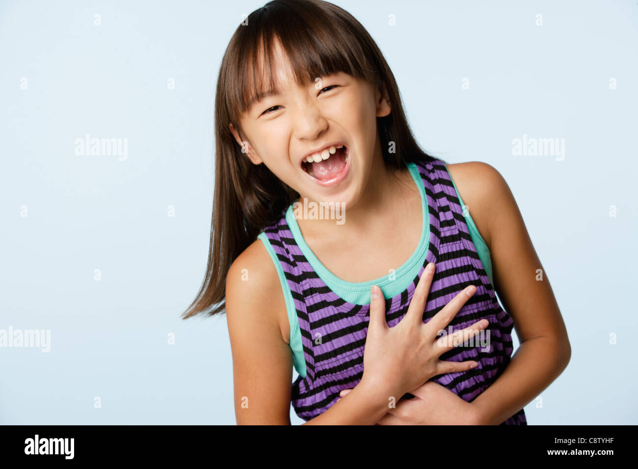 Studio portrait of girl laughing Stock Photo - Alamy