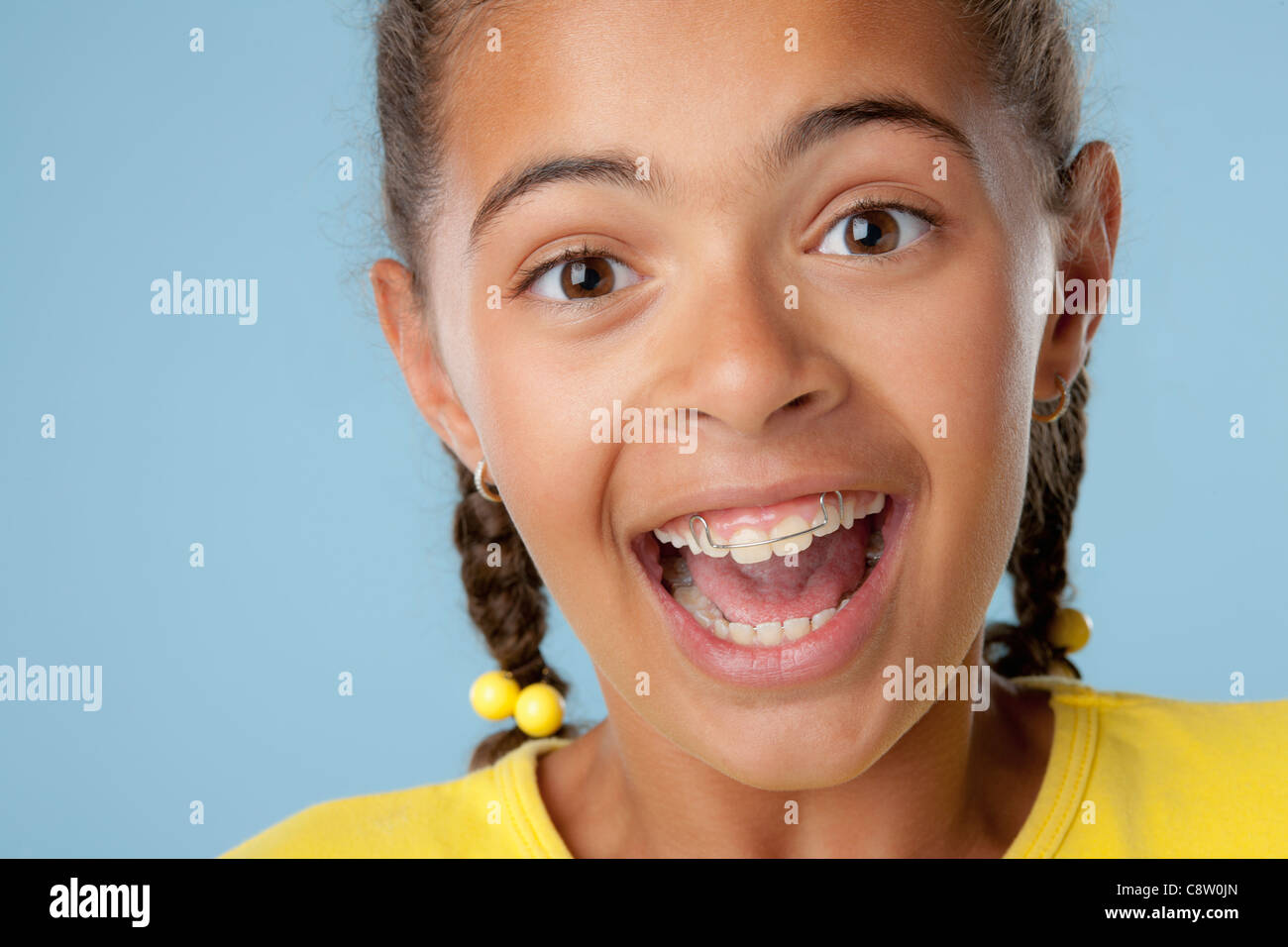 Studio portrait of girl laughing Stock Photo - Alamy