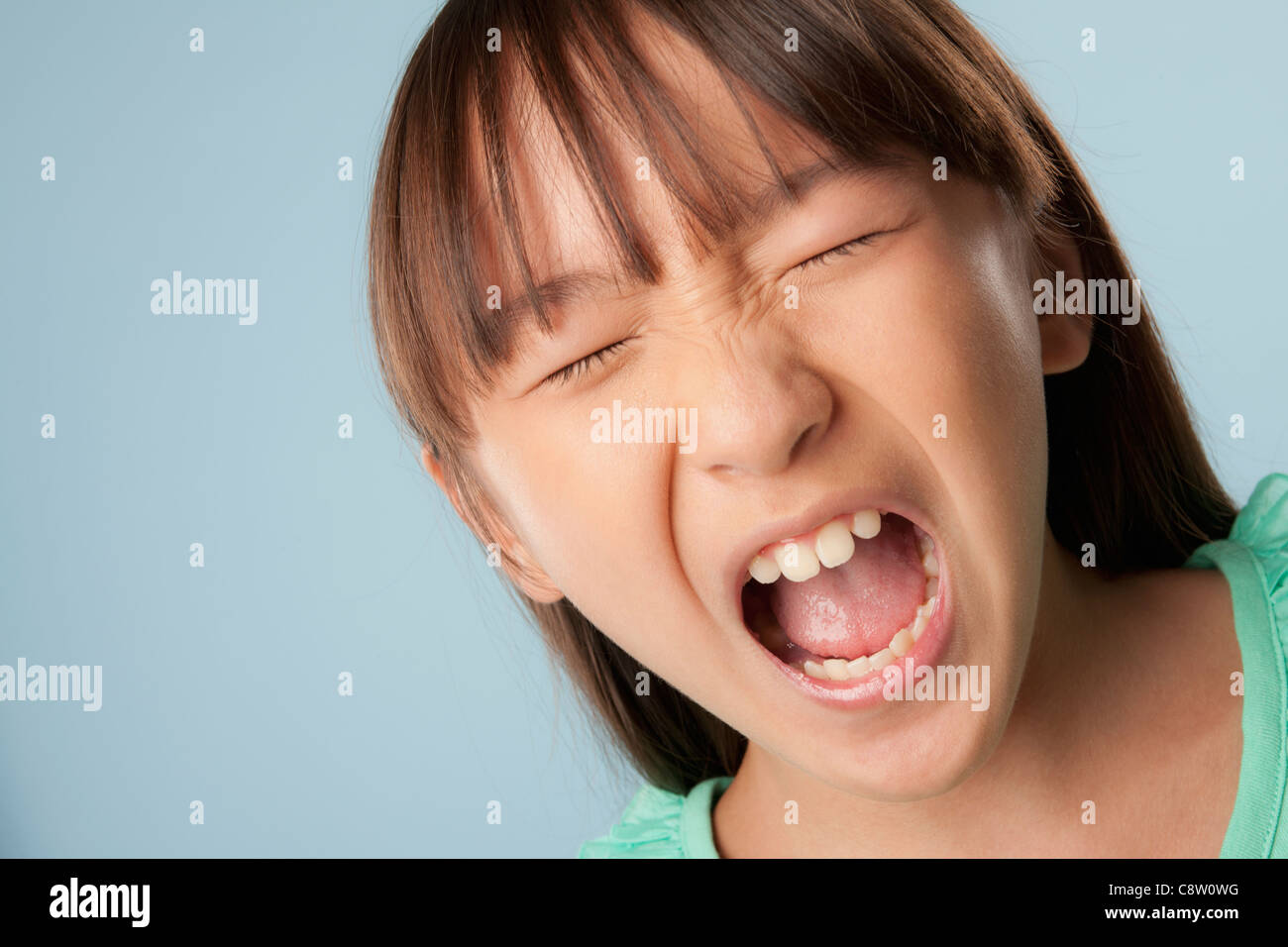 Studio portrait of girl shouting Stock Photo - Alamy