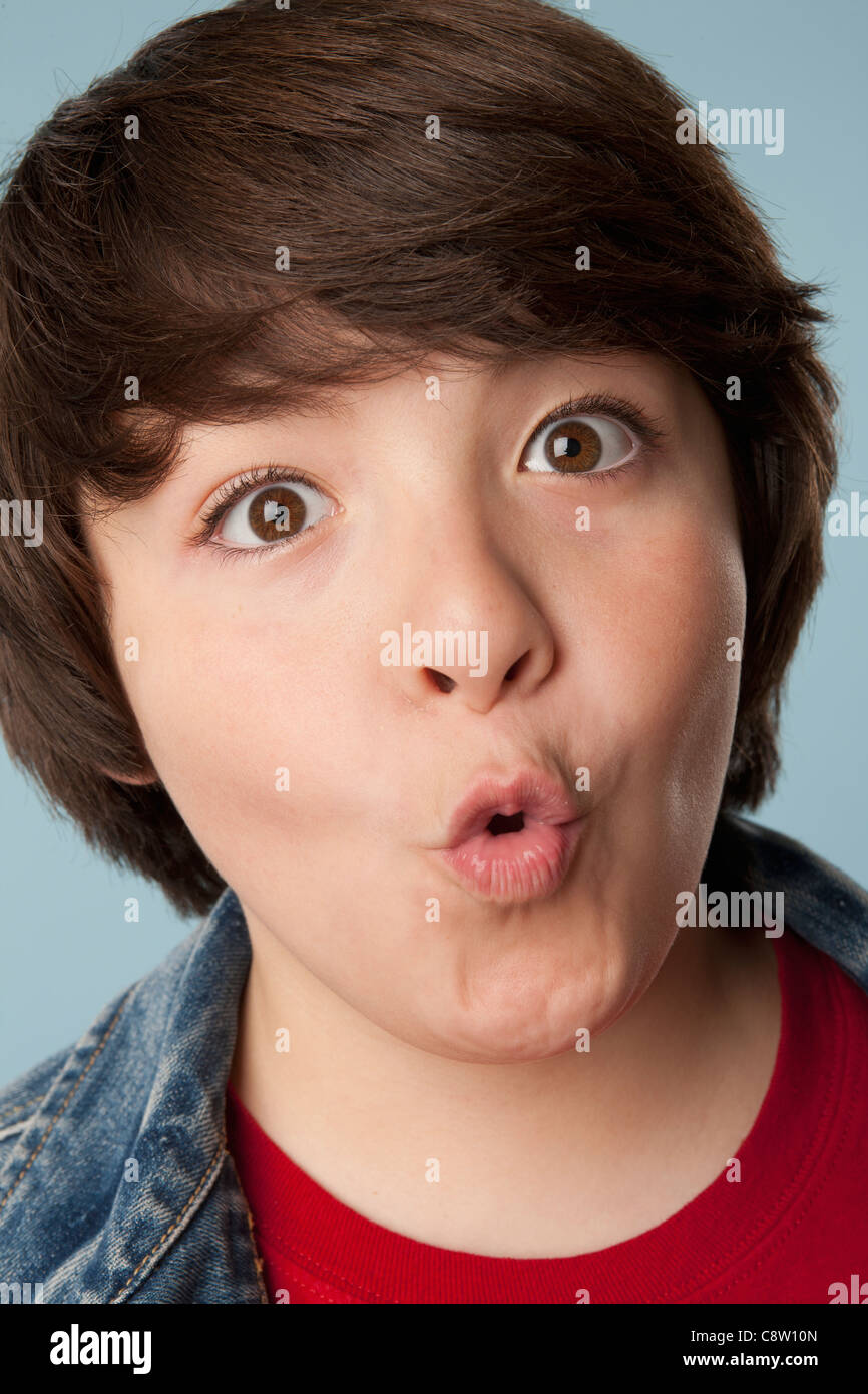 Studio portrait of boy making a face Stock Photo - Alamy