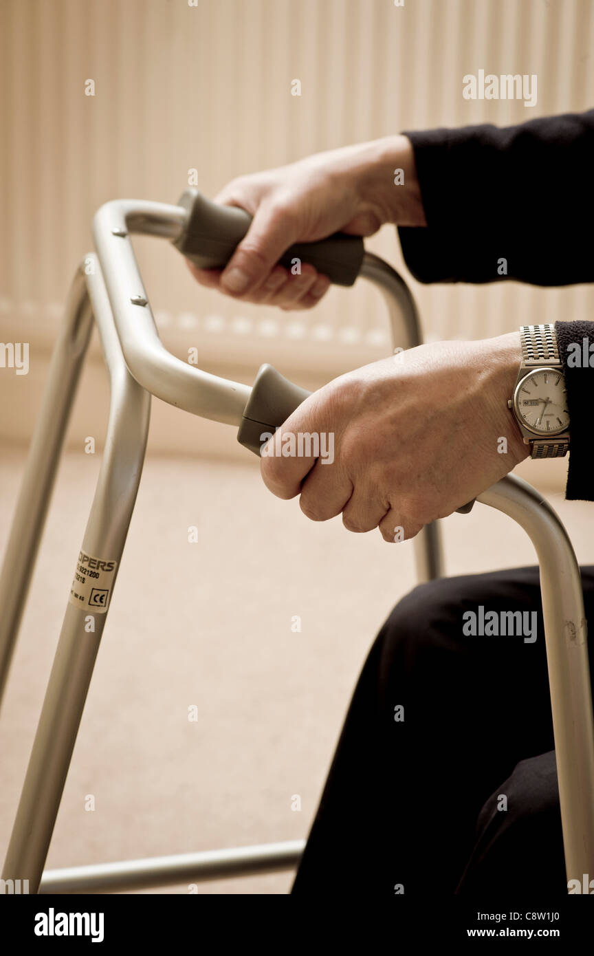 Closeup of caucasian, unidentifiable male holding onto a Zimmer frame ...