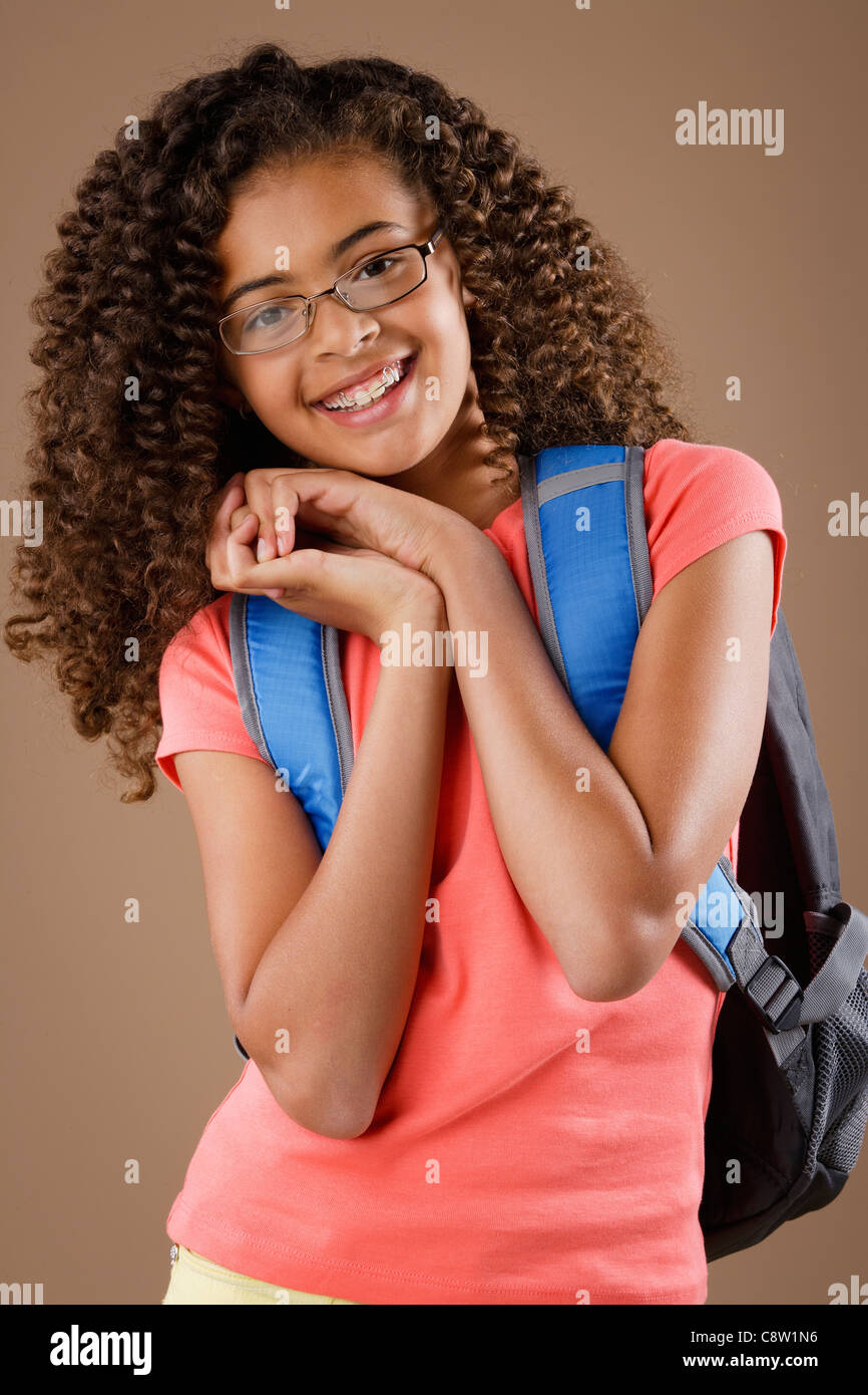 Studio portrait of girl wearing backpack Stock Photo - Alamy