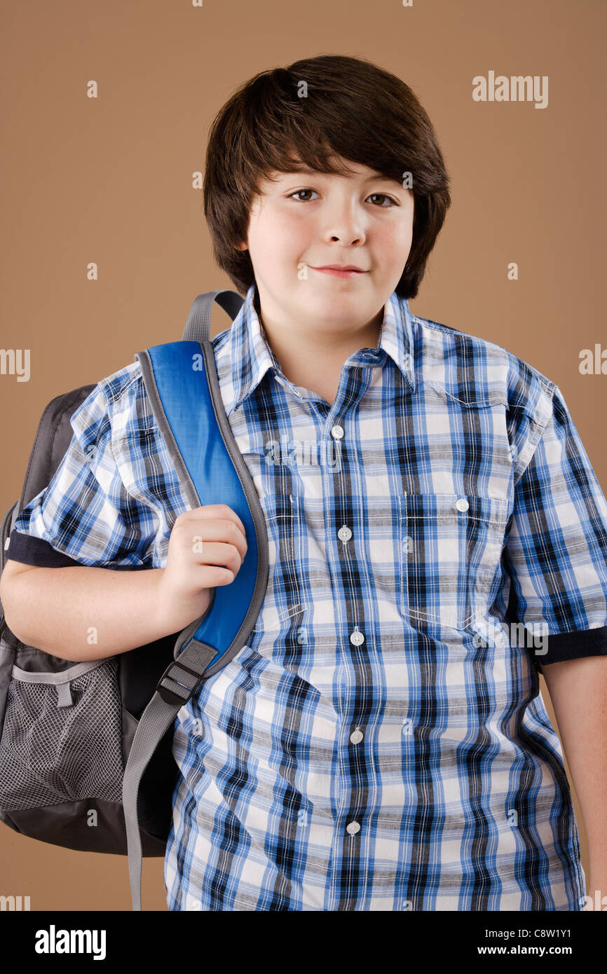 Studio portrait of boy wearing backpack Stock Photo - Alamy