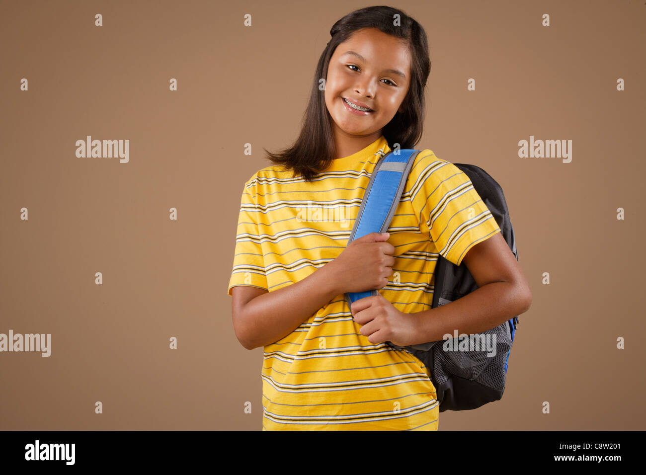 Studio portrait of girl wearing backpack Stock Photo - Alamy