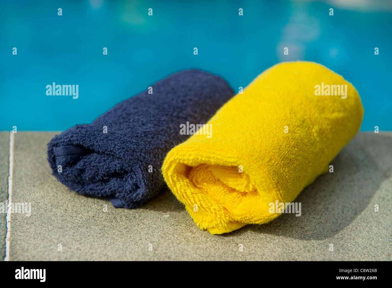 Towels in blue and yellow near the swimming pool Stock Photo - Alamy