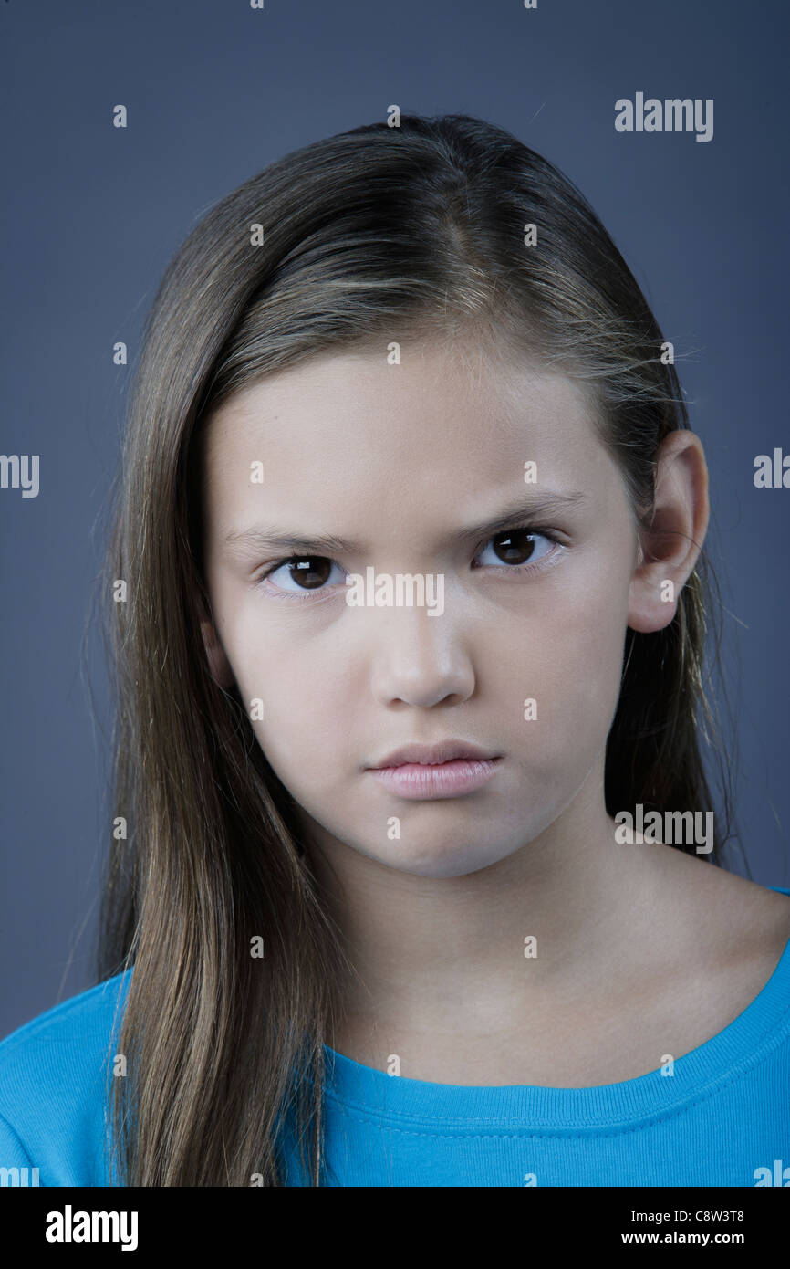 Portrait of girl looking angry, studio shot Stock Photo - Alamy