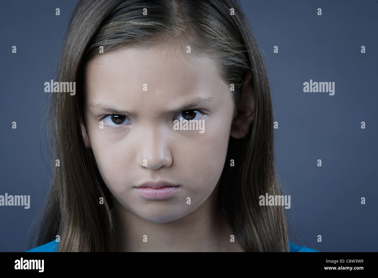 Portrait of girl looking angry, studio shot Stock Photo - Alamy