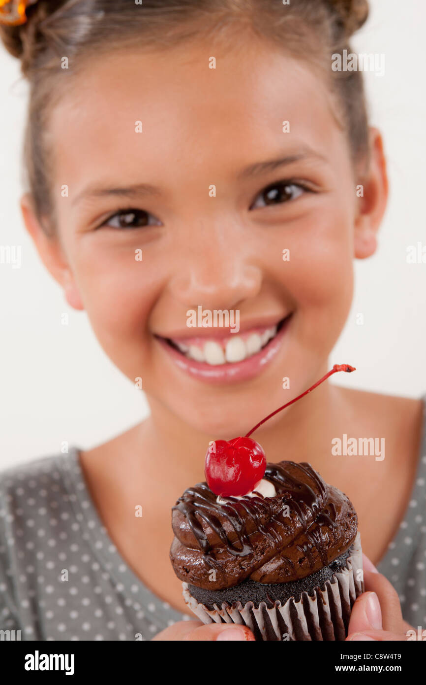 Studio portrait of girl holding cake Stock Photo - Alamy