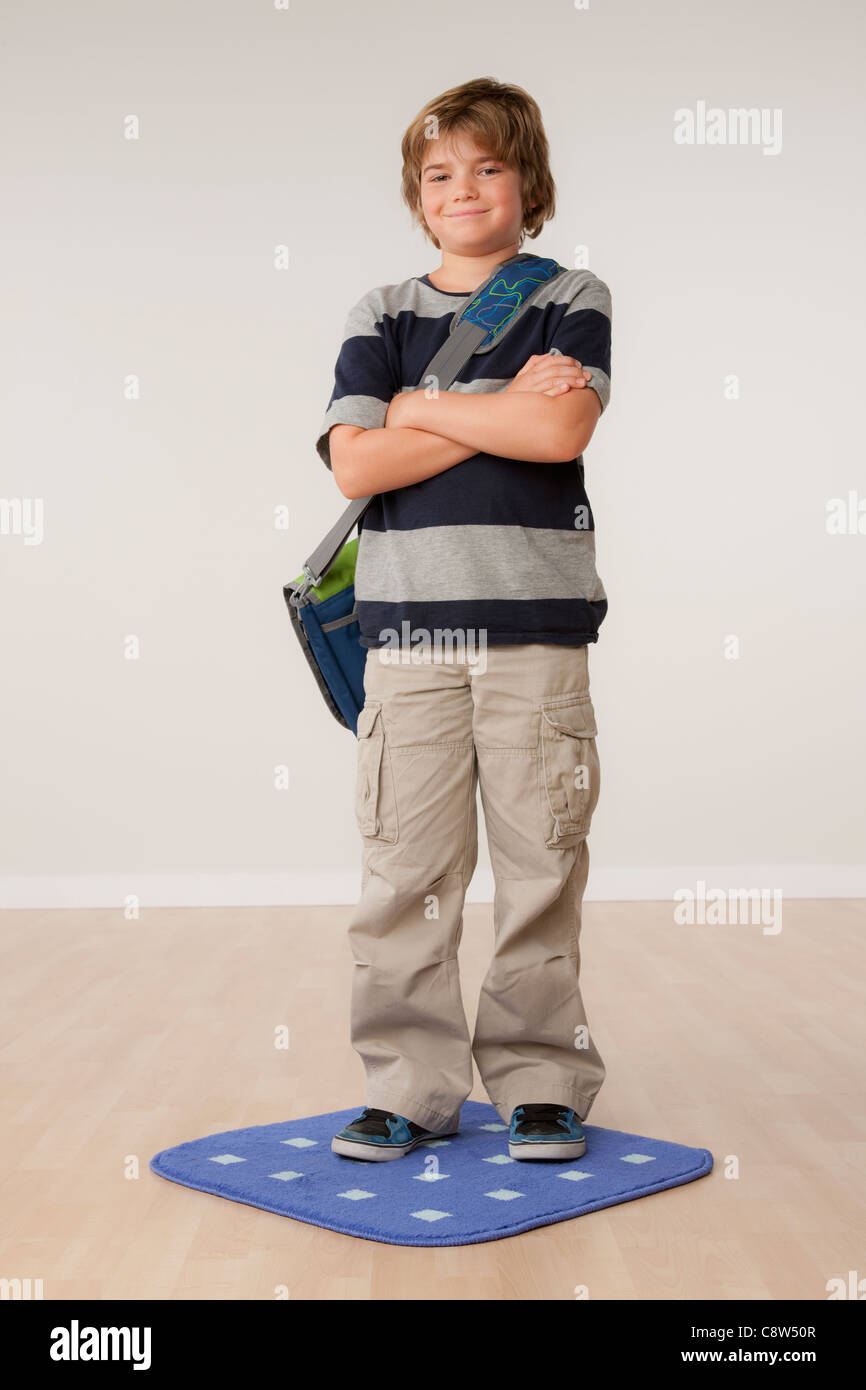 Studio portrait of boy carrying backpack Stock Photo - Alamy