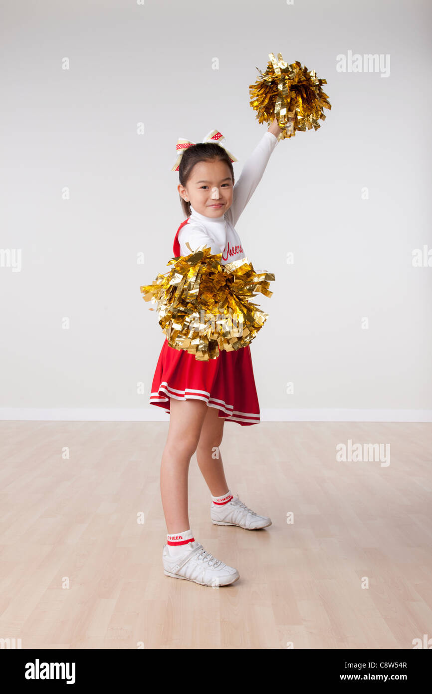 Studio portrait of girl cheerleading Stock Photo - Alamy