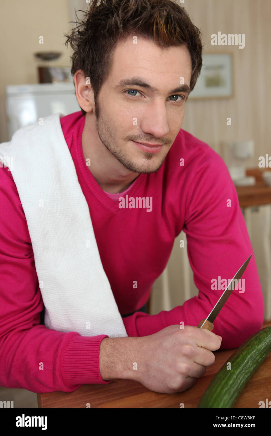 Man in kitchen with knife Stock Photo - Alamy