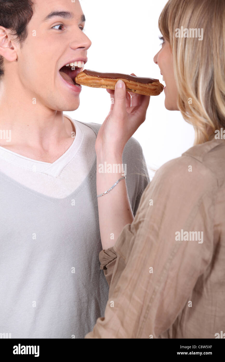 Couple eating a pastry Stock Photo - Alamy