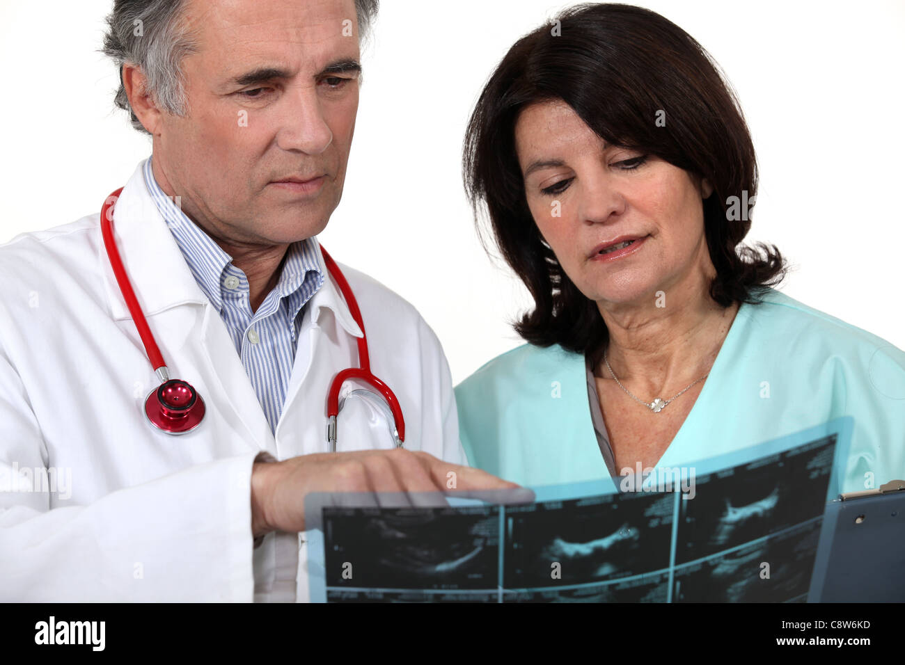 A doctor and a nurse looking at radios Stock Photo - Alamy