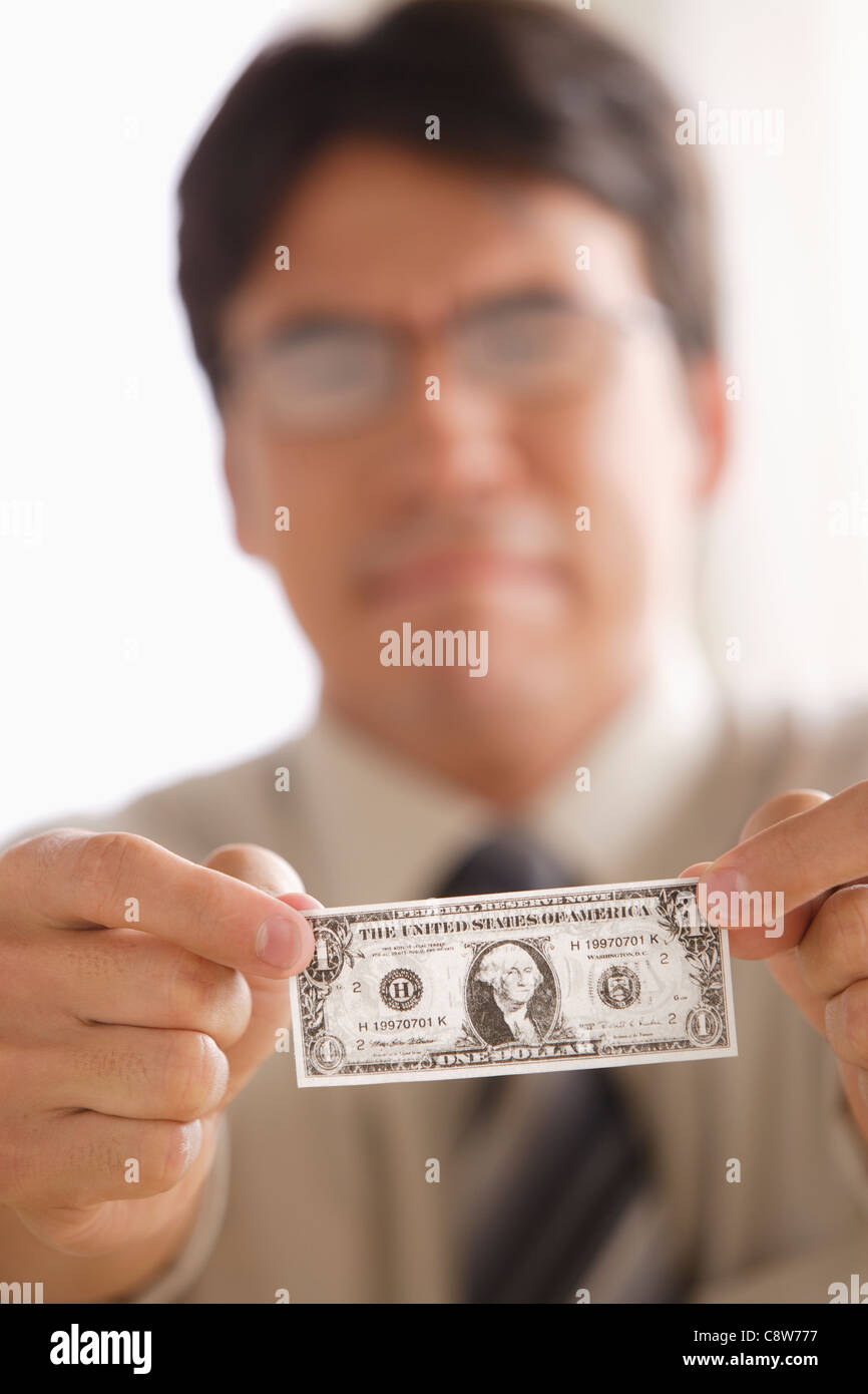 Sad business man holding one dollar note Stock Photo - Alamy