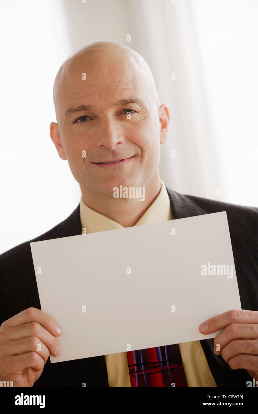 Man holding blank paper hi-res stock photography and images - Alamy